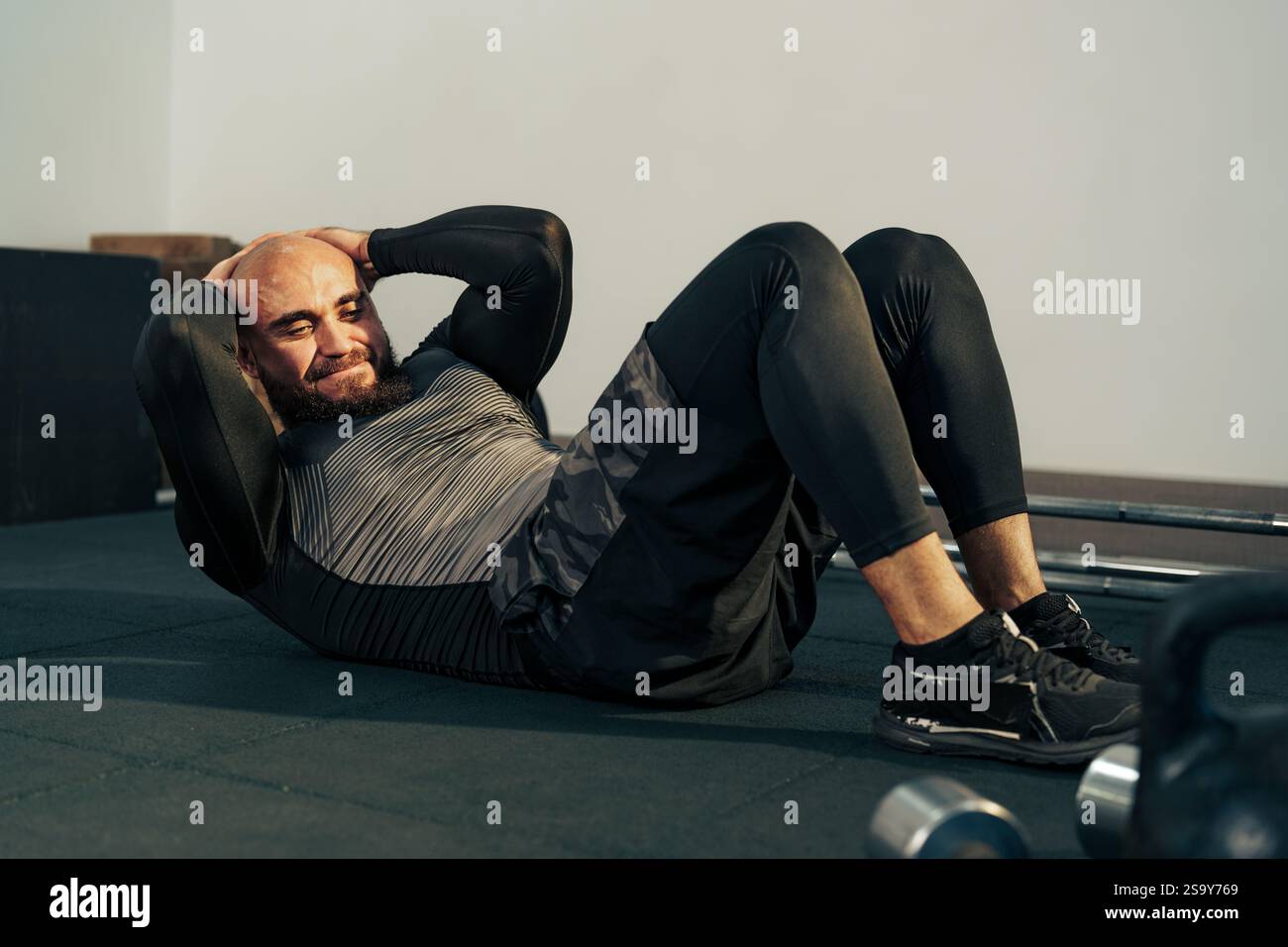 Fitness enthusiast performing crunches in a gym environment during a ...