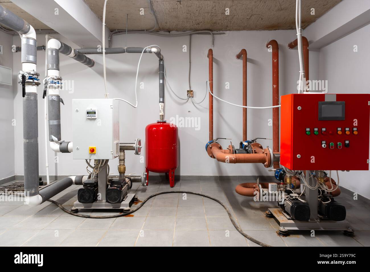 Water pump system installation in a basement utility room with various ...