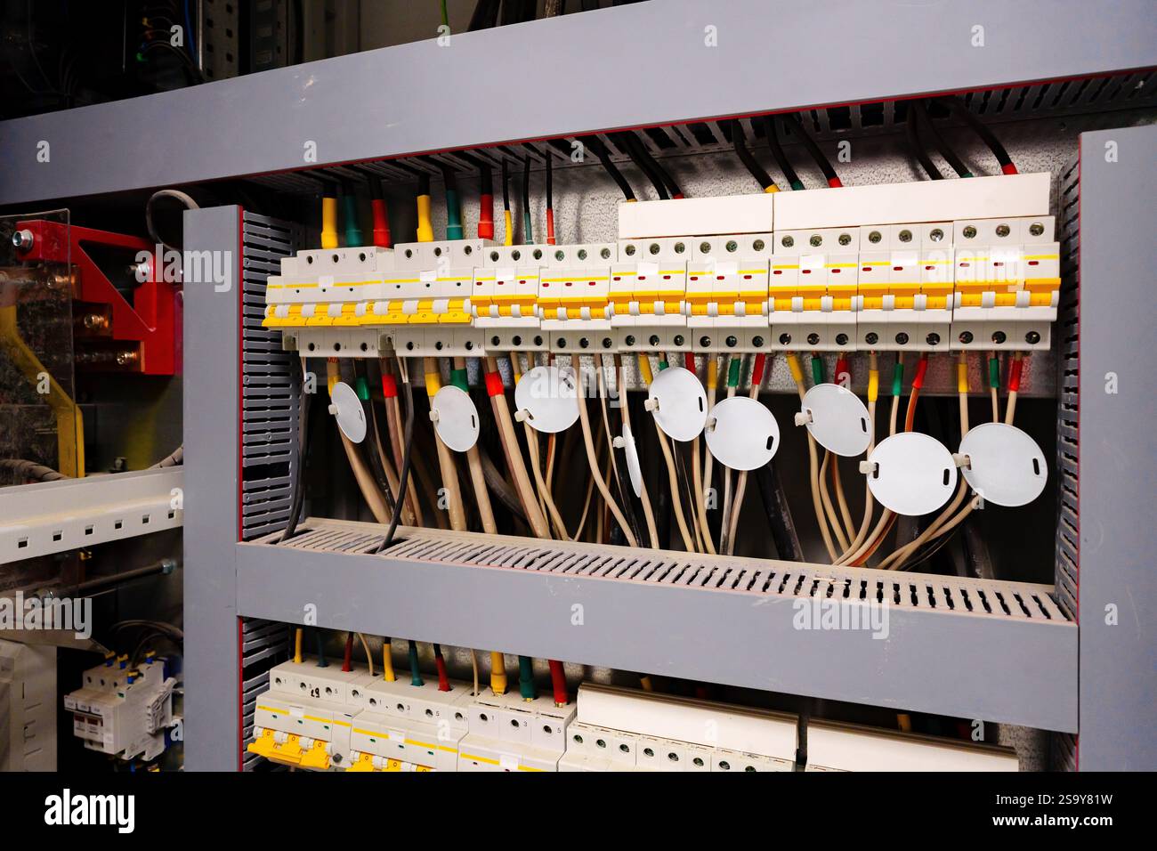 Detailed view of electrical panel with circuit breakers and wiring in a ...