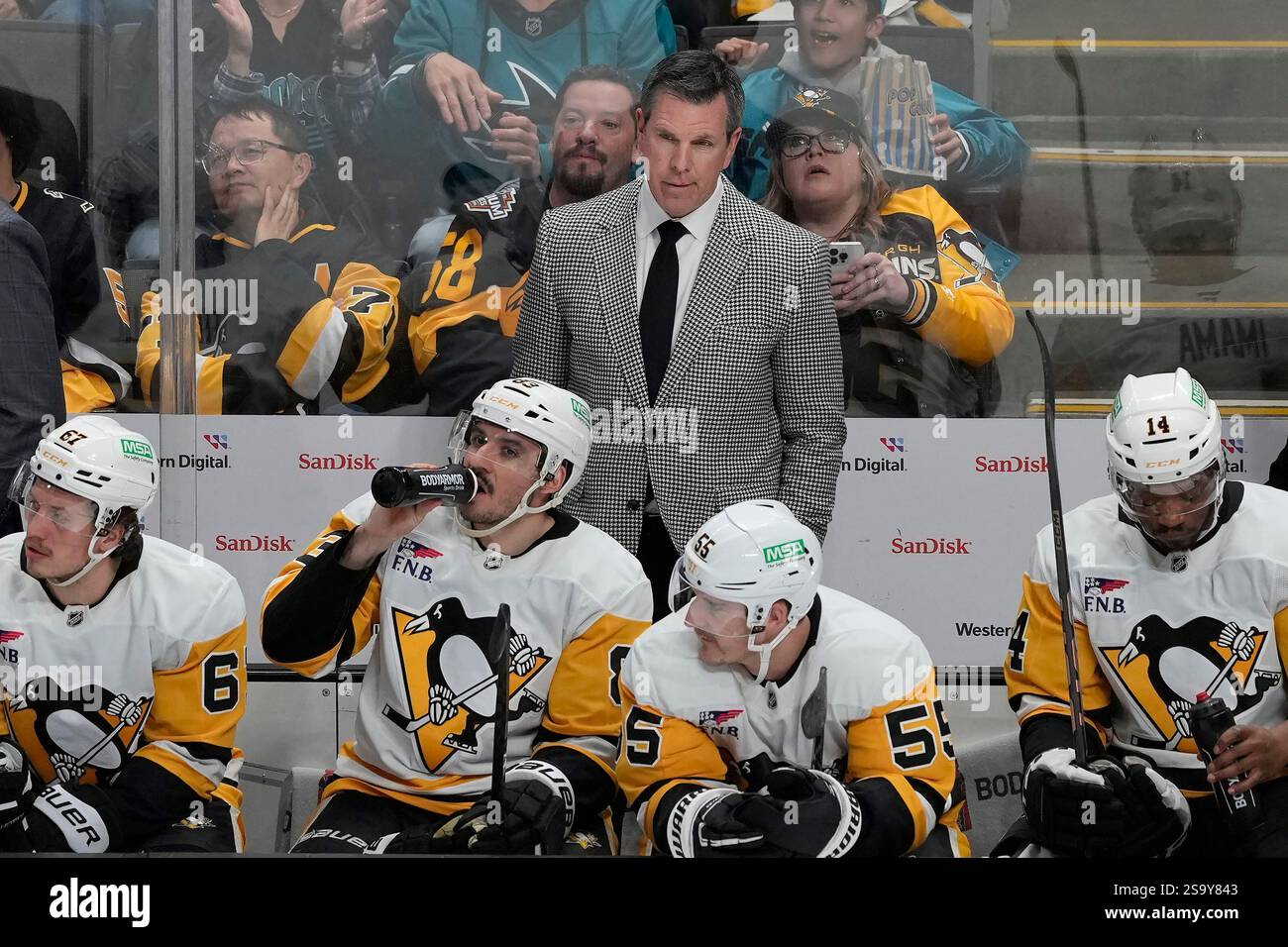 Pittsburgh Penguins head coach Mike Sullivan, standing, reacts behind ...