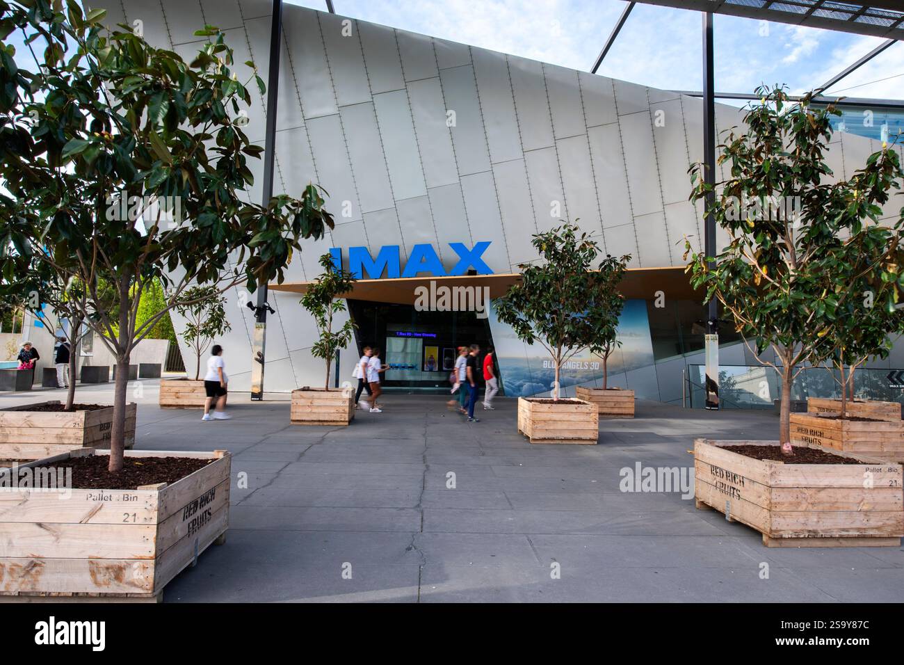 Visitors walking under sloping roof, striking architecture and stark ...