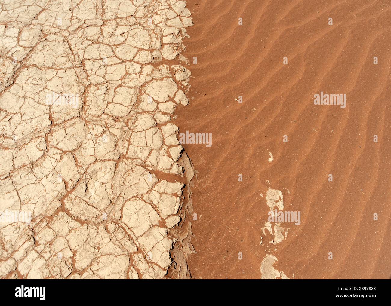 dry clay border with red sand waves from Namib desert Stock Photo - Alamy