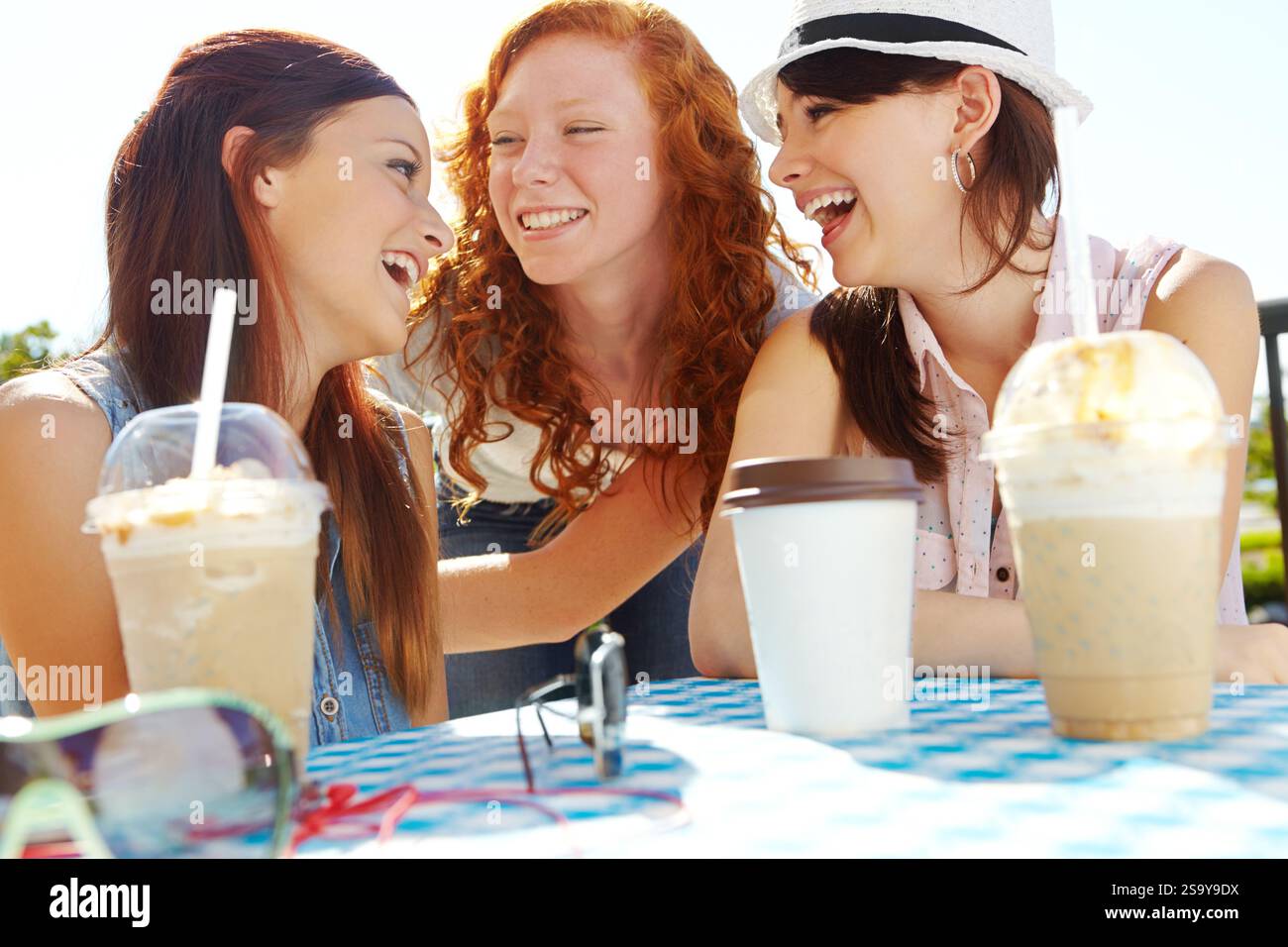 Happy, friends and girls in cafe for talking, social hangout and chill ...