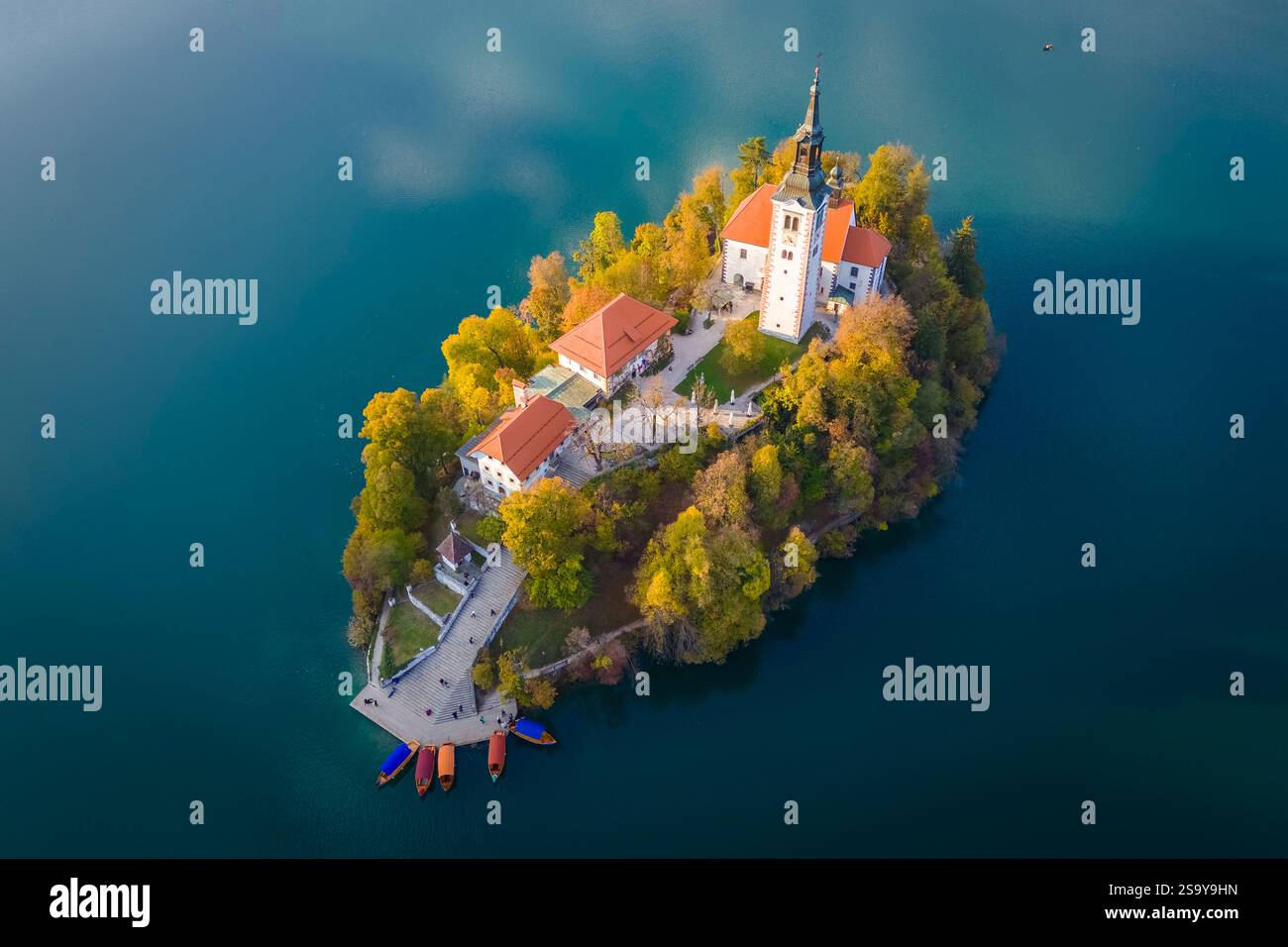 Aerial view of Bled island on Lake Bled in autumn at sunset. Bled ...