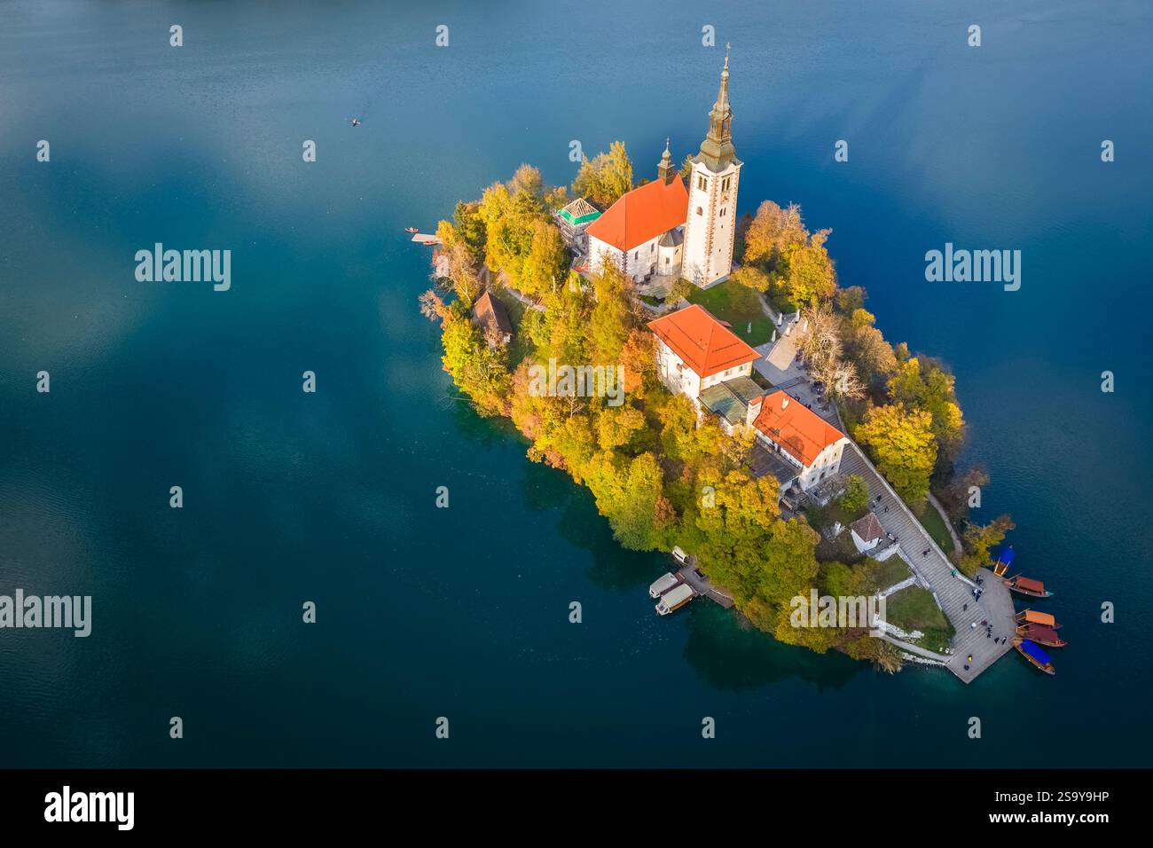 Aerial view of Bled island on Lake Bled in autumn at sunset. Bled ...