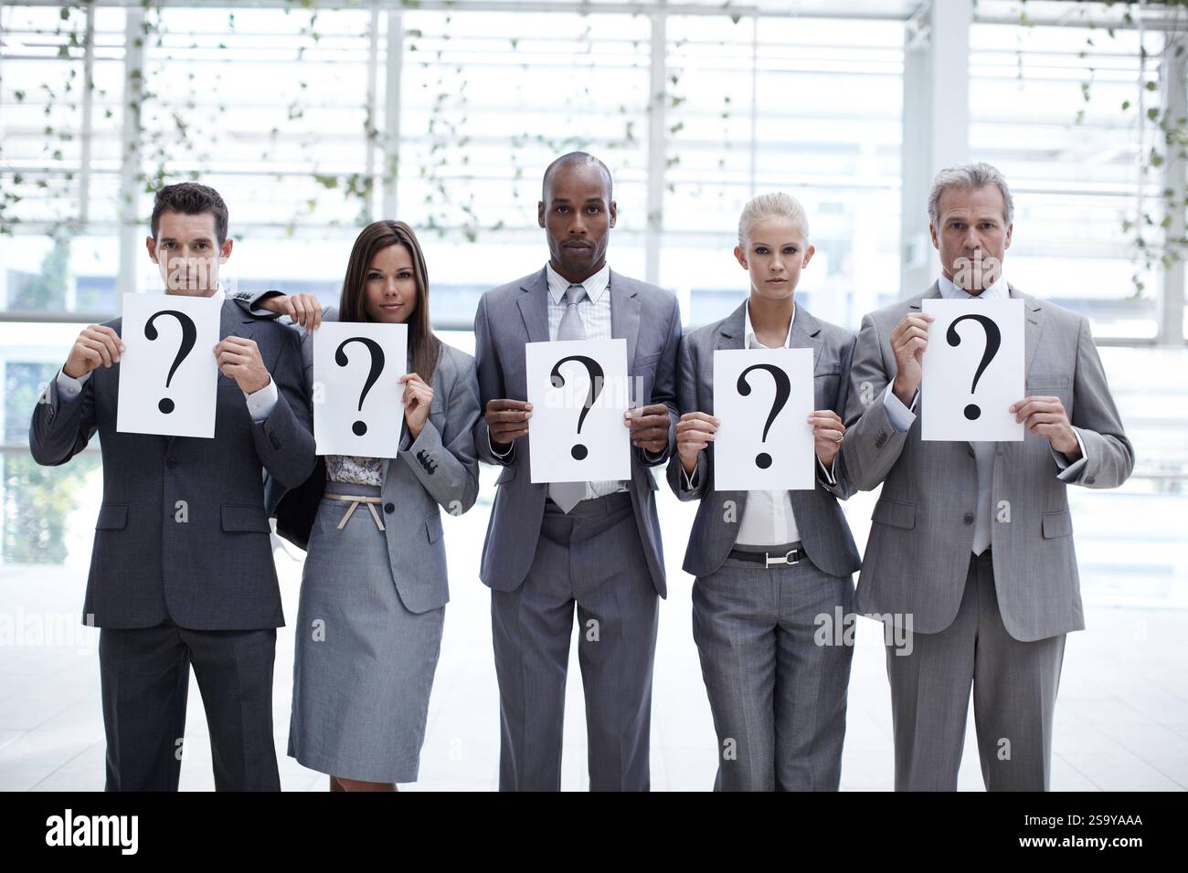 Portrait, business and people with question marks in office for ...