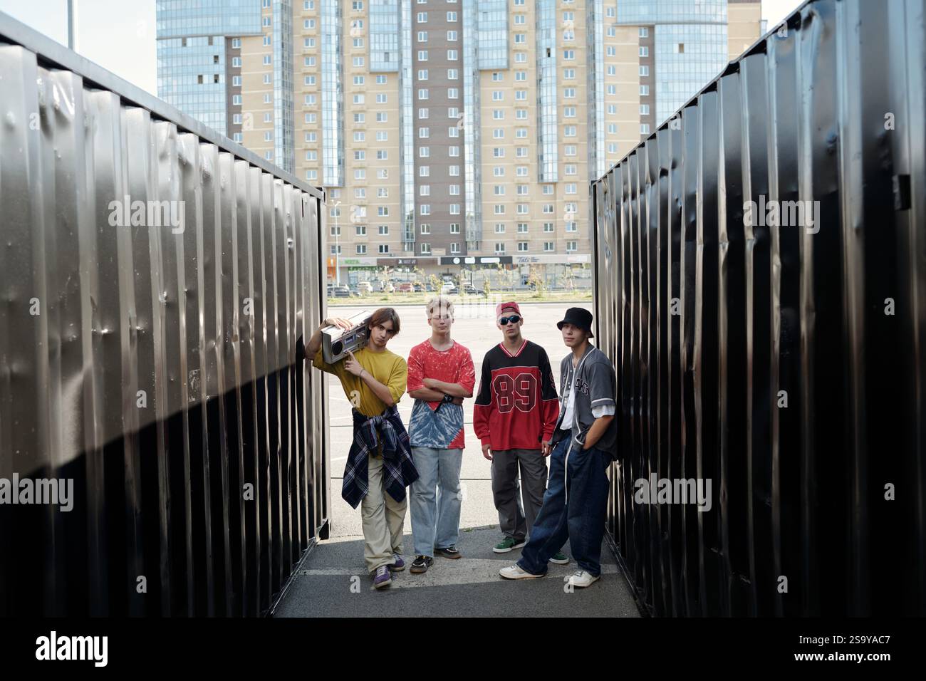 Group of Friends Standing Between Shipping Containers Stock Photo - Alamy