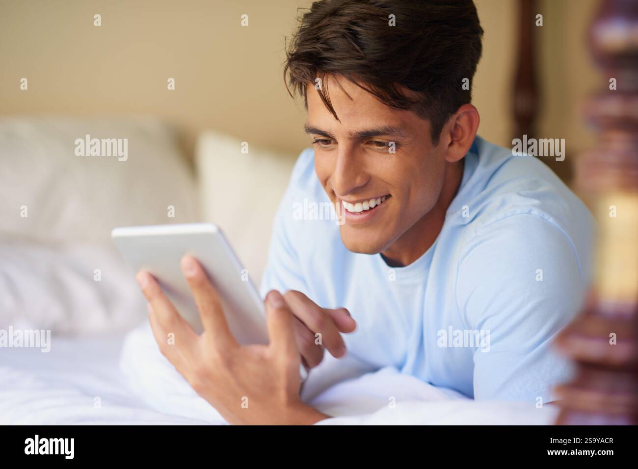 Bedroom, smile and man with tablet, relax and internet for social media ...
