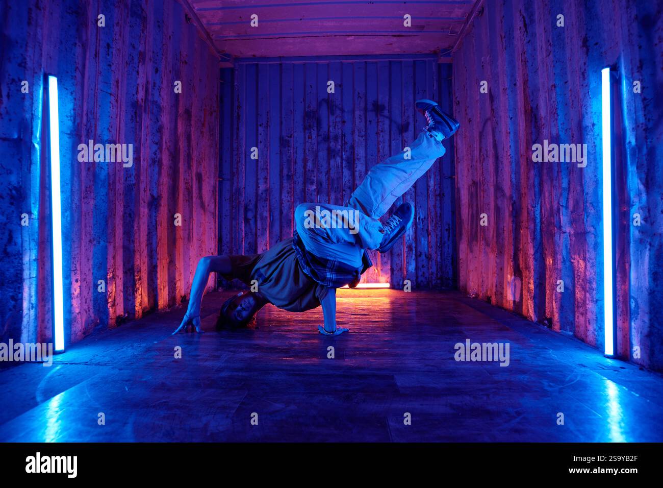 Breakdancing in Industrial-Lit Room with Neon Lights Stock Photo - Alamy