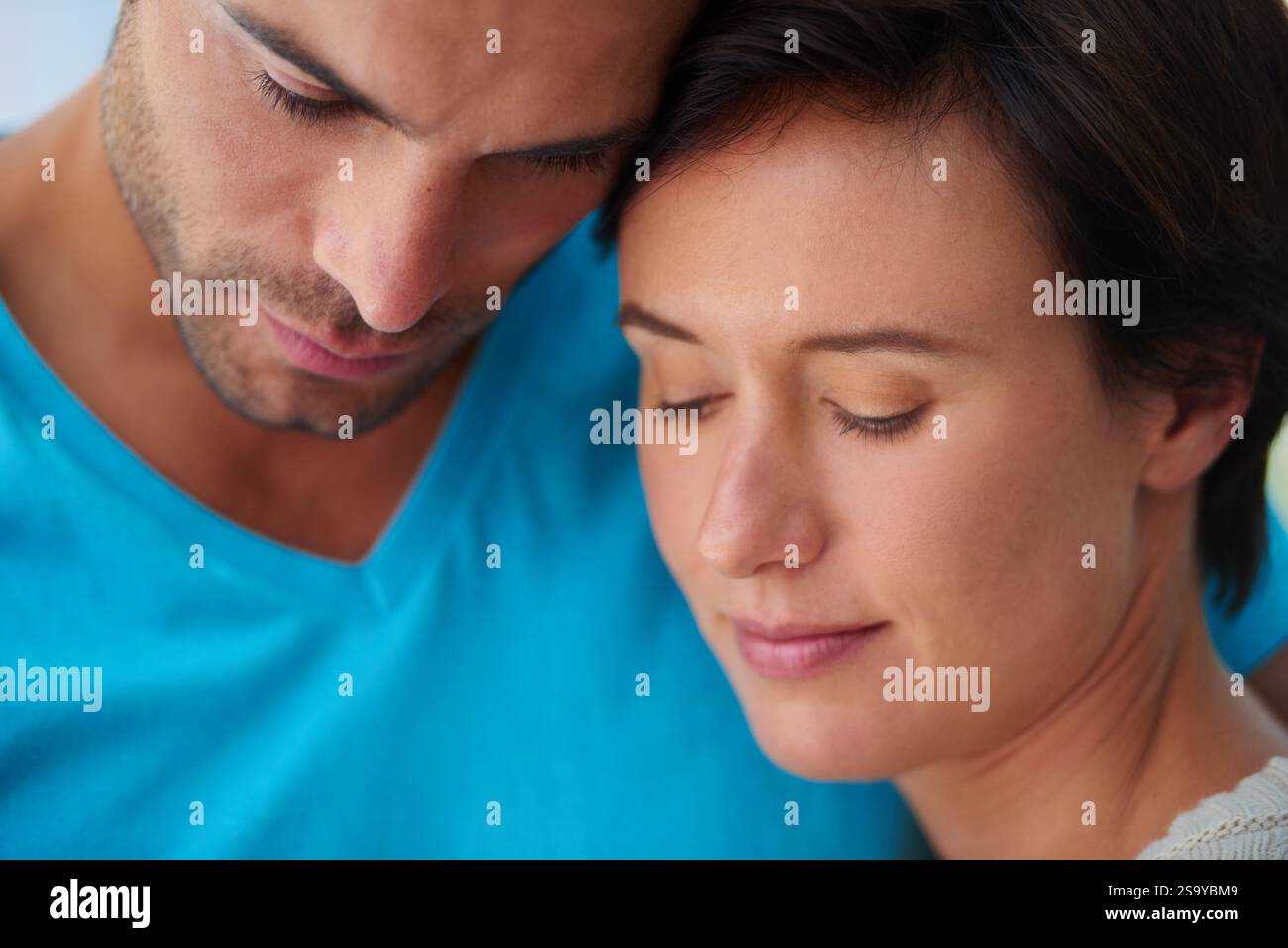 Love, couple and forehead touch for support, care and bonding together ...