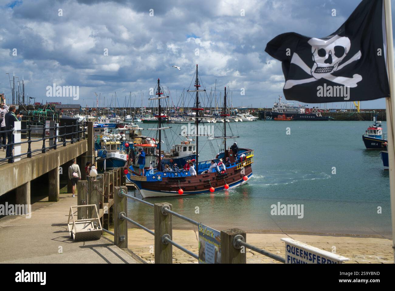 Scarborough harbour, old town, beneath Castle hill. Photograph looks ...