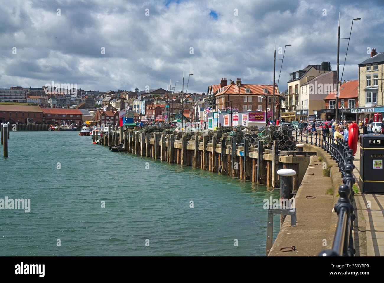 Scarborough harbour, old town, beneath Castle hill. Photograph looks ...