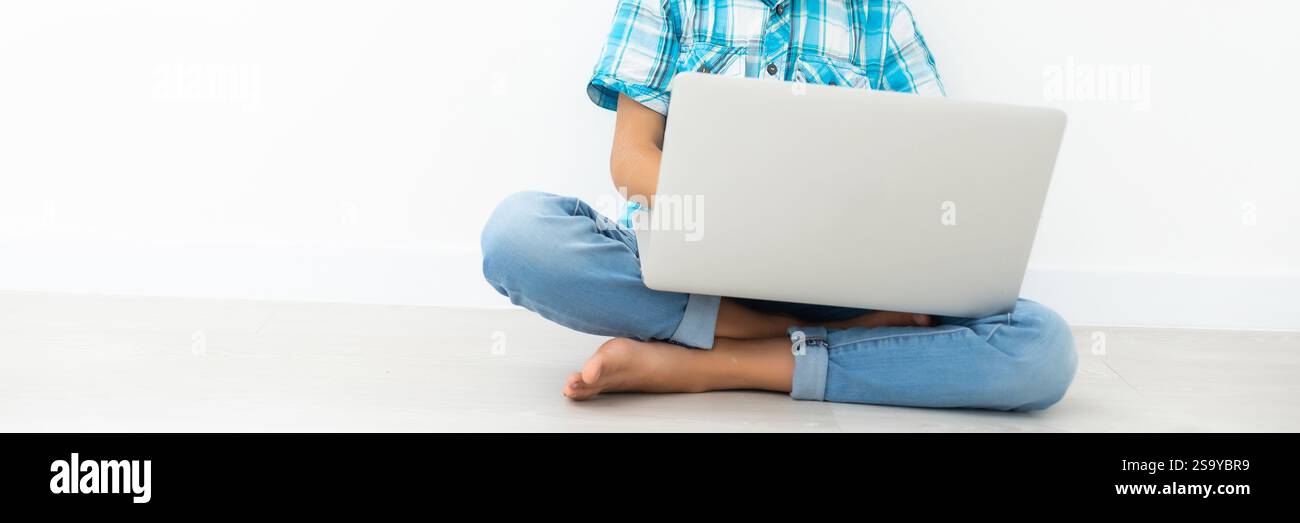 Little kid studying on his laptop. Concept about childhood and ...