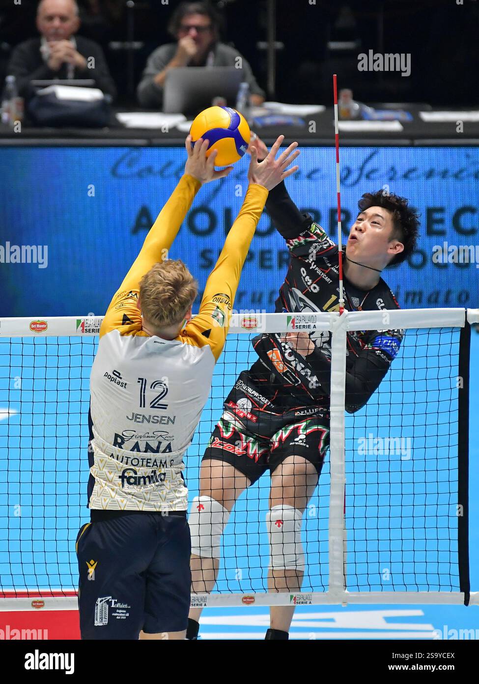 Yuki ISHIKAWA attacks the ball trying to overcome the block of Mads ...