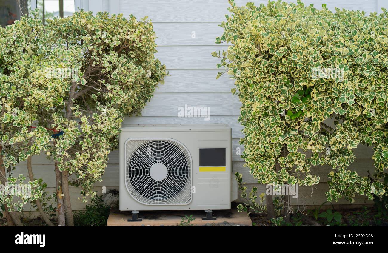 The air compressor with house and garden in background. Green renewable ...