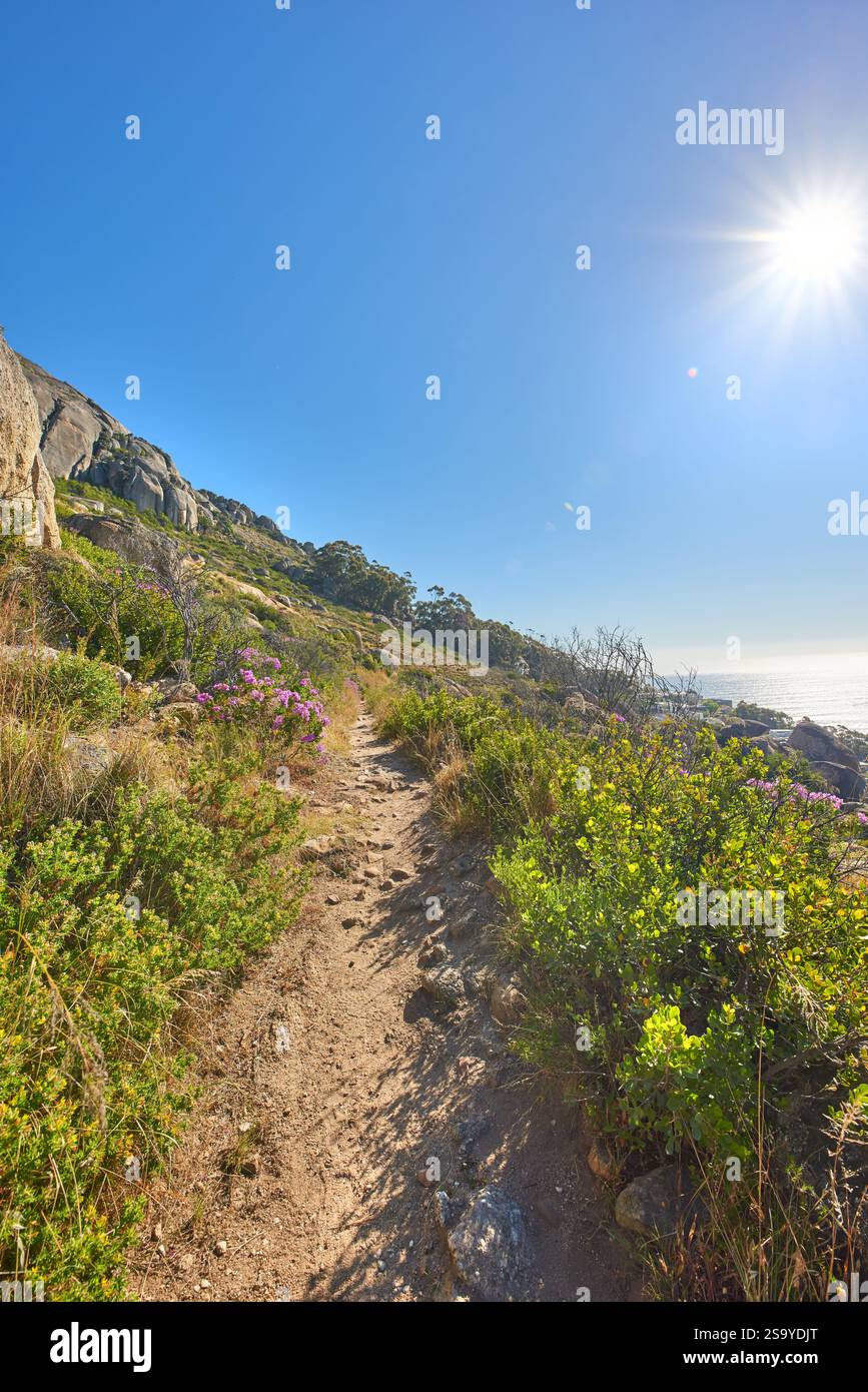 Hill, pathway and trail with blue sky in environment for summit hiking ...