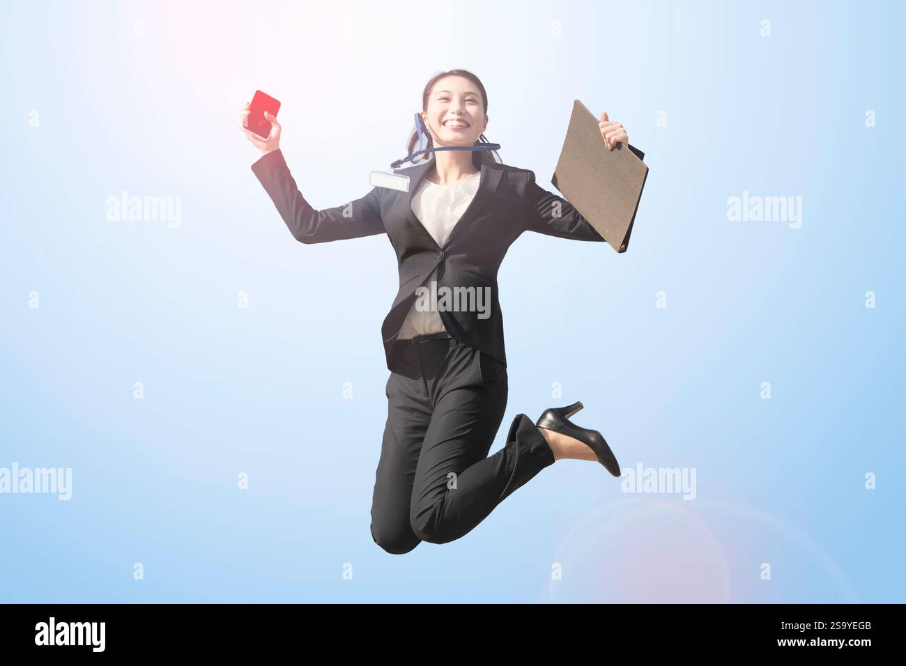 Young businesswoman/jobseeker jumping with a smile Stock Photo - Alamy