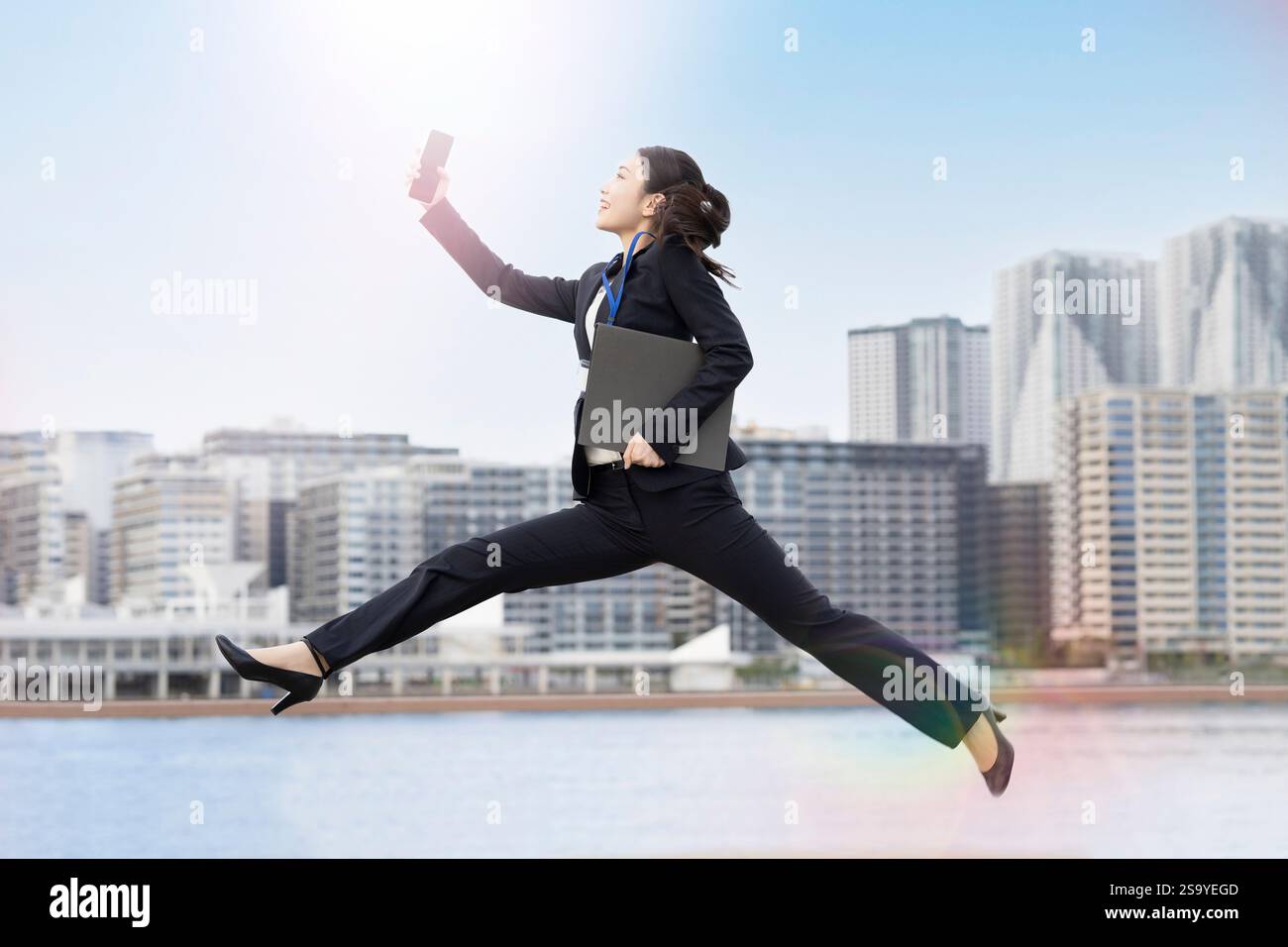 Young businesswoman/jobseeker jumping with a smile Stock Photo - Alamy