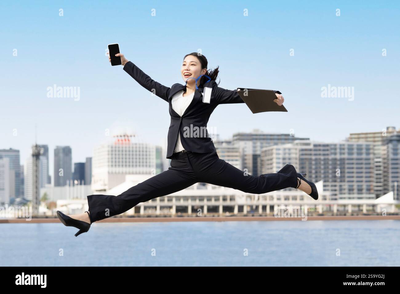 Young businesswoman/jobseeker jumping with a smile Stock Photo - Alamy
