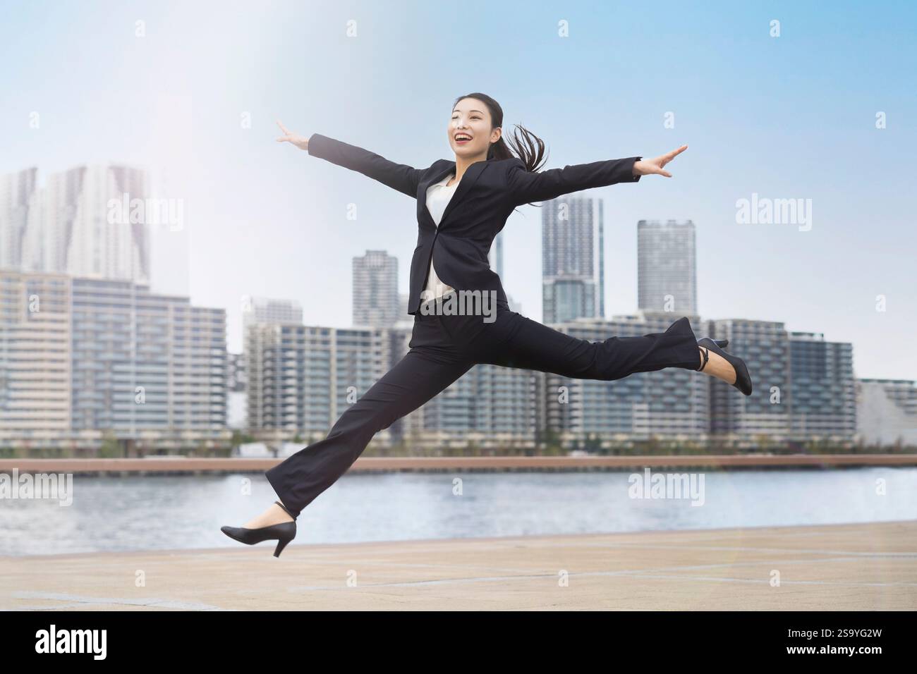 Young businesswoman/jobseeker jumping with a smile Stock Photo - Alamy