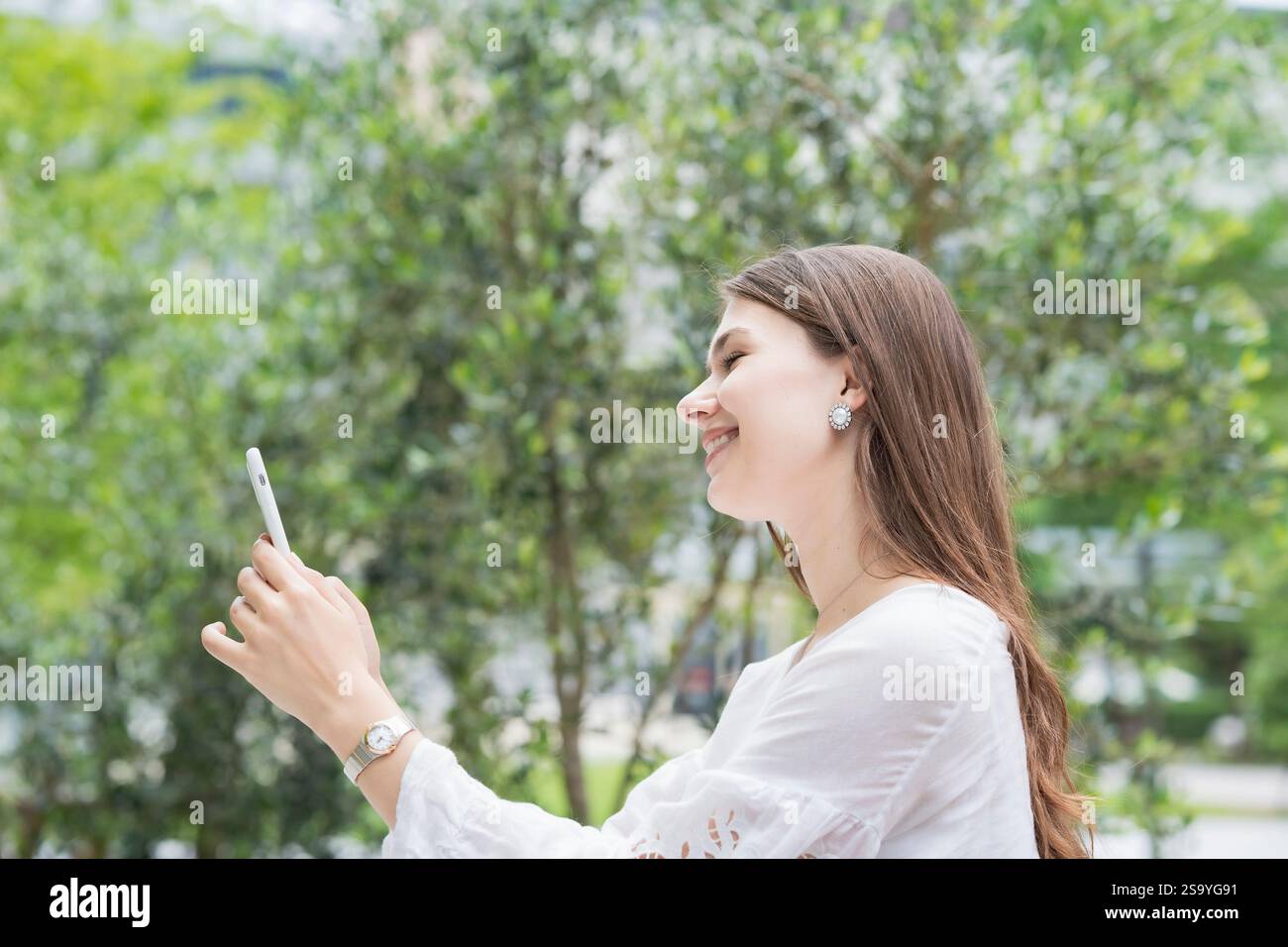 Woman operating a smartphone Stock Photo - Alamy