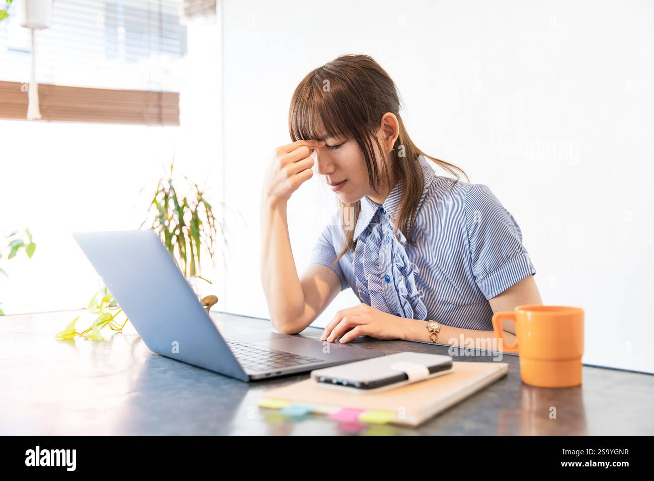 Woman tired of working remotely Stock Photo - Alamy