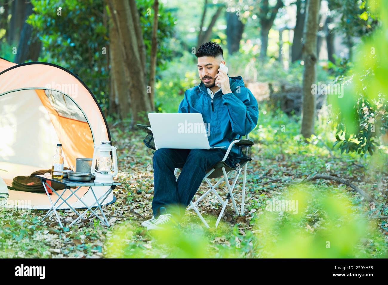 Men working while camping Stock Photo - Alamy