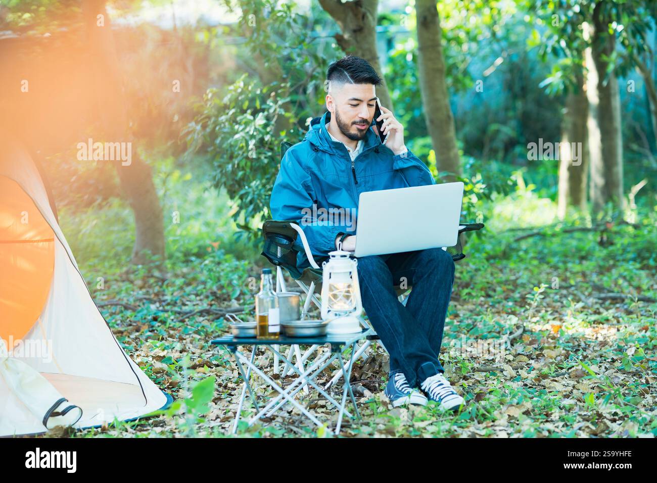 Men working while camping Stock Photo - Alamy