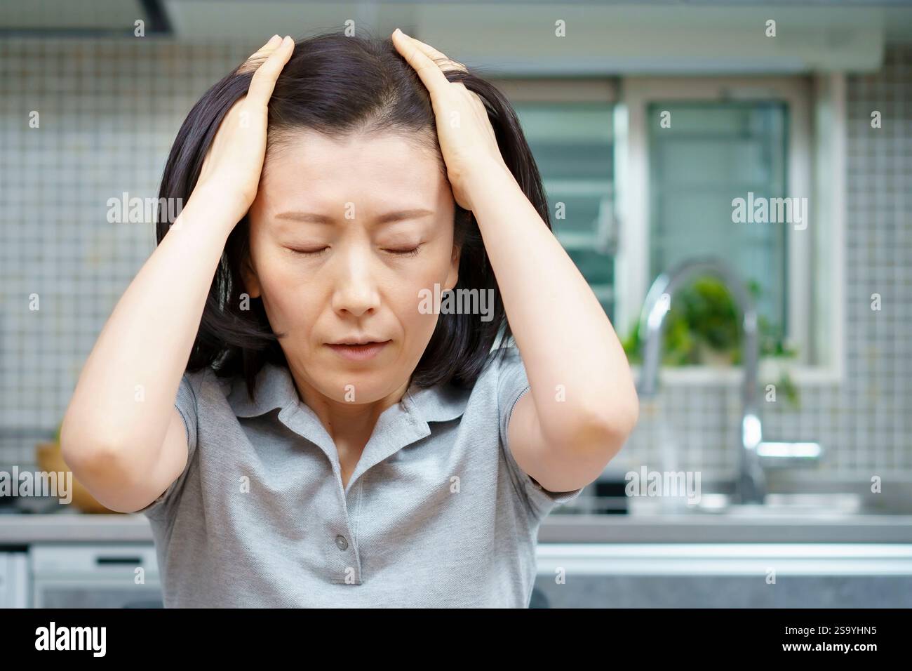 Woman with a tired expression Stock Photo - Alamy