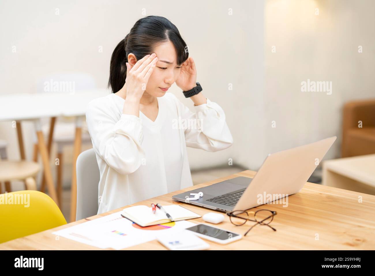 Woman suffering from headache at work Stock Photo - Alamy