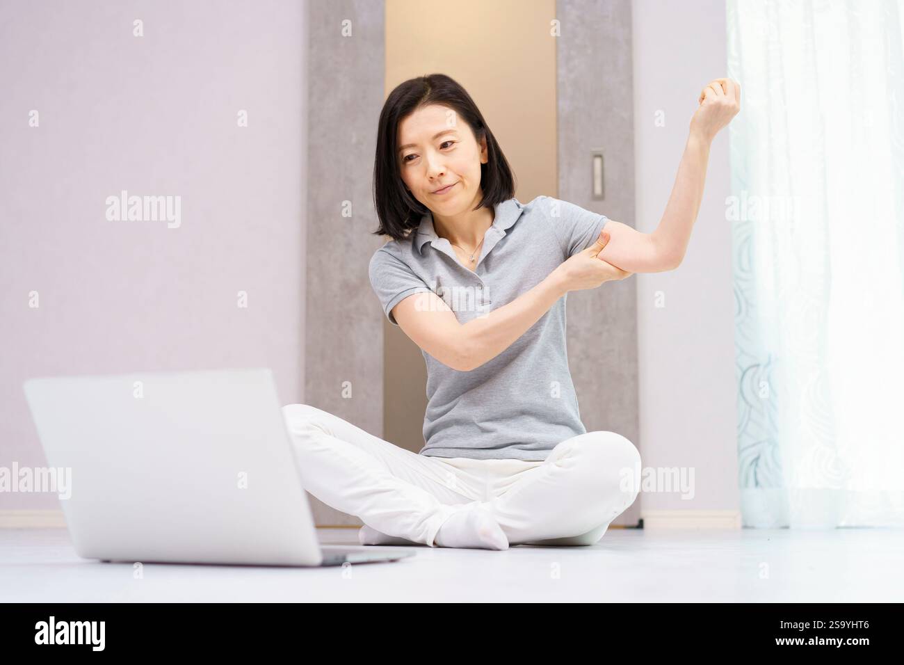Women doing light exercise while looking at a computer (40s and 50s ...