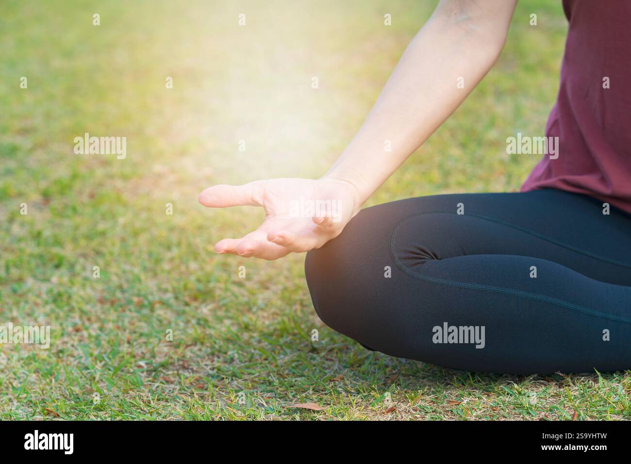 Young woman doing yoga in a park full of greenery Body parts of young ...