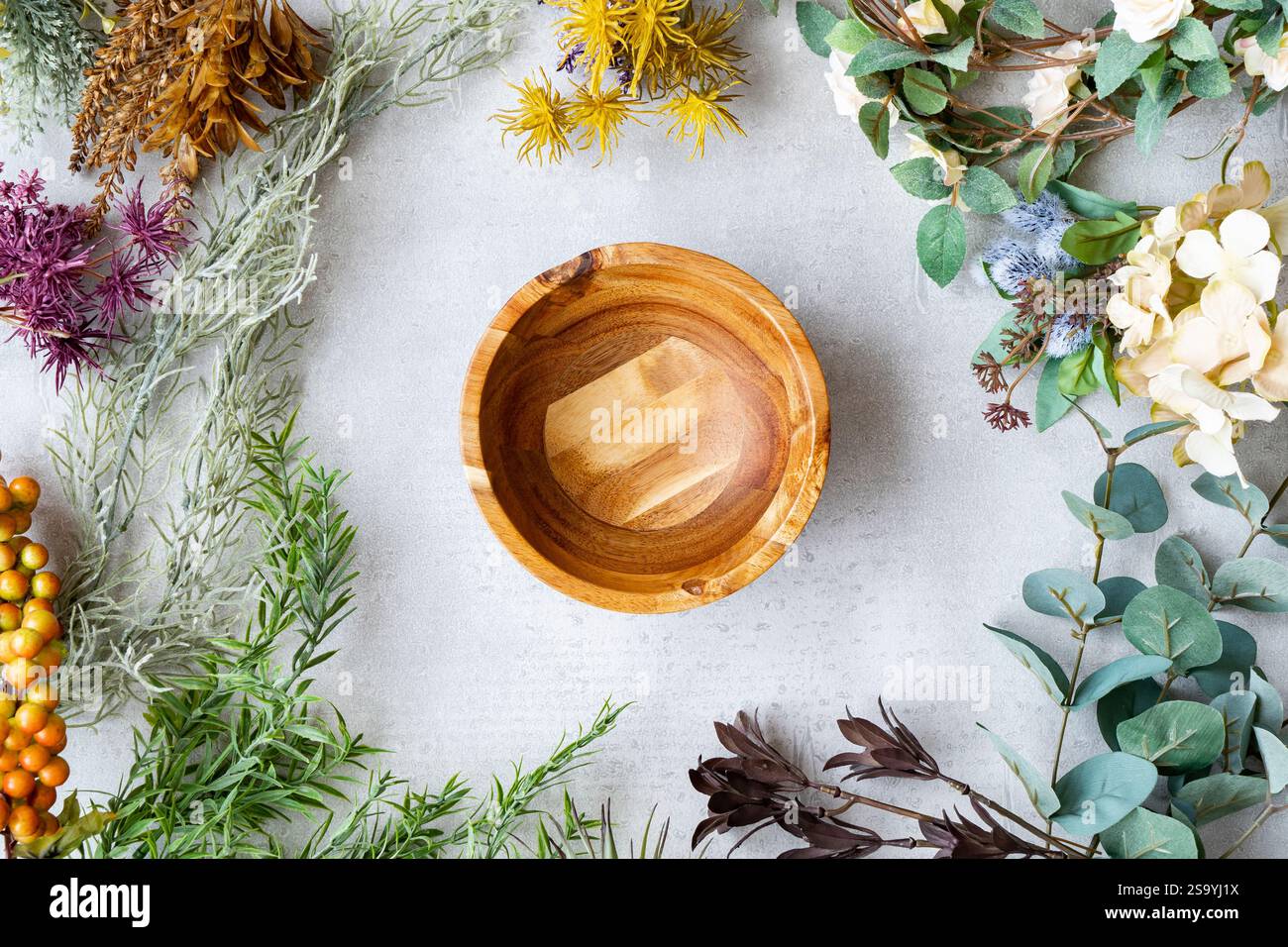 Decorative objects made of wooden plates and plants set on a marble ...