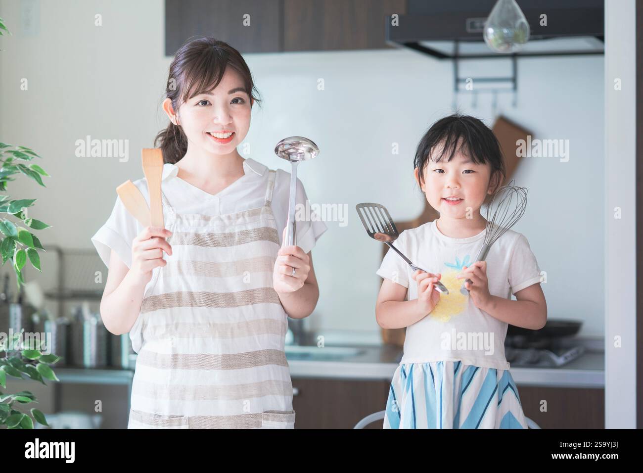 Parents and children trying cooking Stock Photo - Alamy
