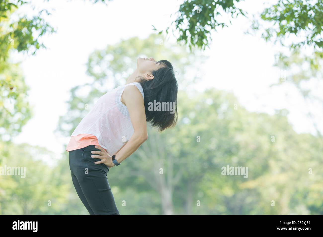 Woman taking a deep breath during exercise Stock Photo - Alamy