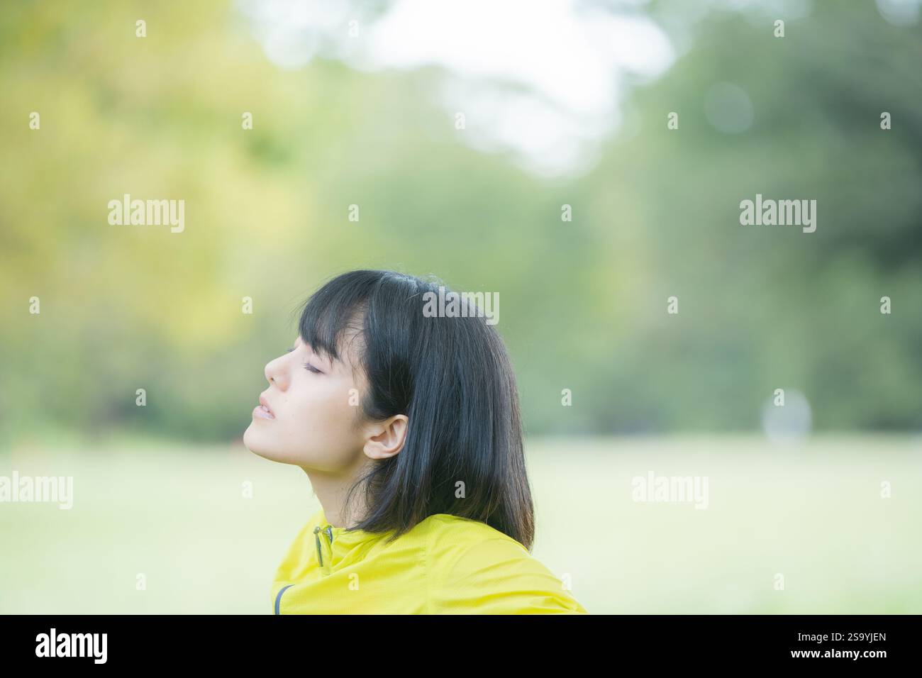 Woman taking a deep breath during exercise Stock Photo - Alamy