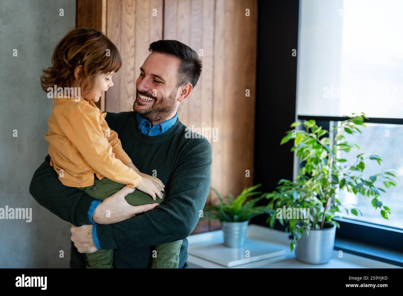 Happy loving daddy and affectionate boy playing, laughing having fun at ...