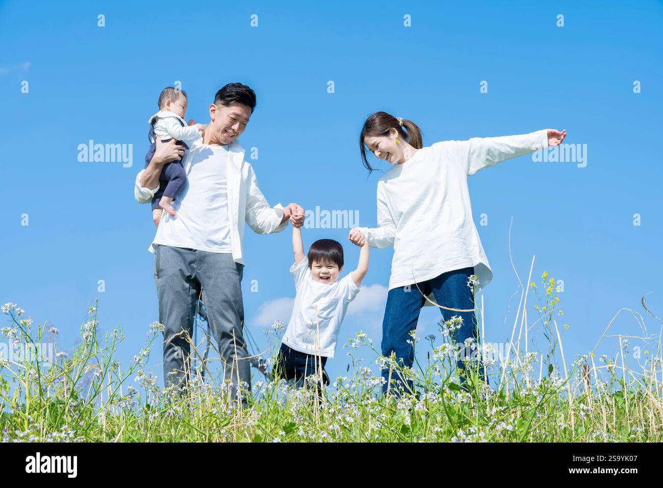 Four smiling and excited parents and children under a blue sky Stock ...
