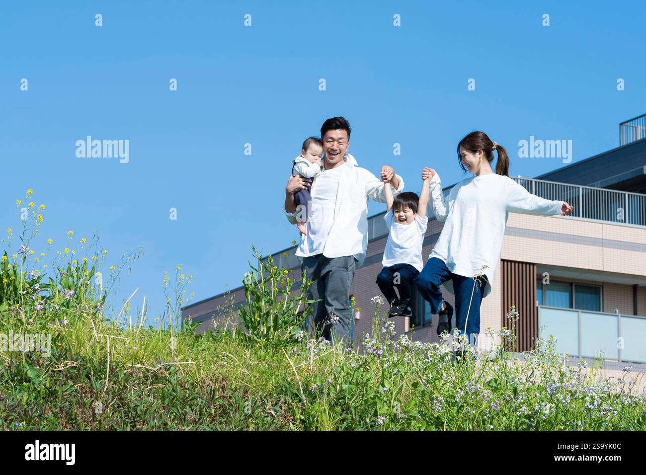 Four smiling and excited parents and children under a blue sky Stock ...