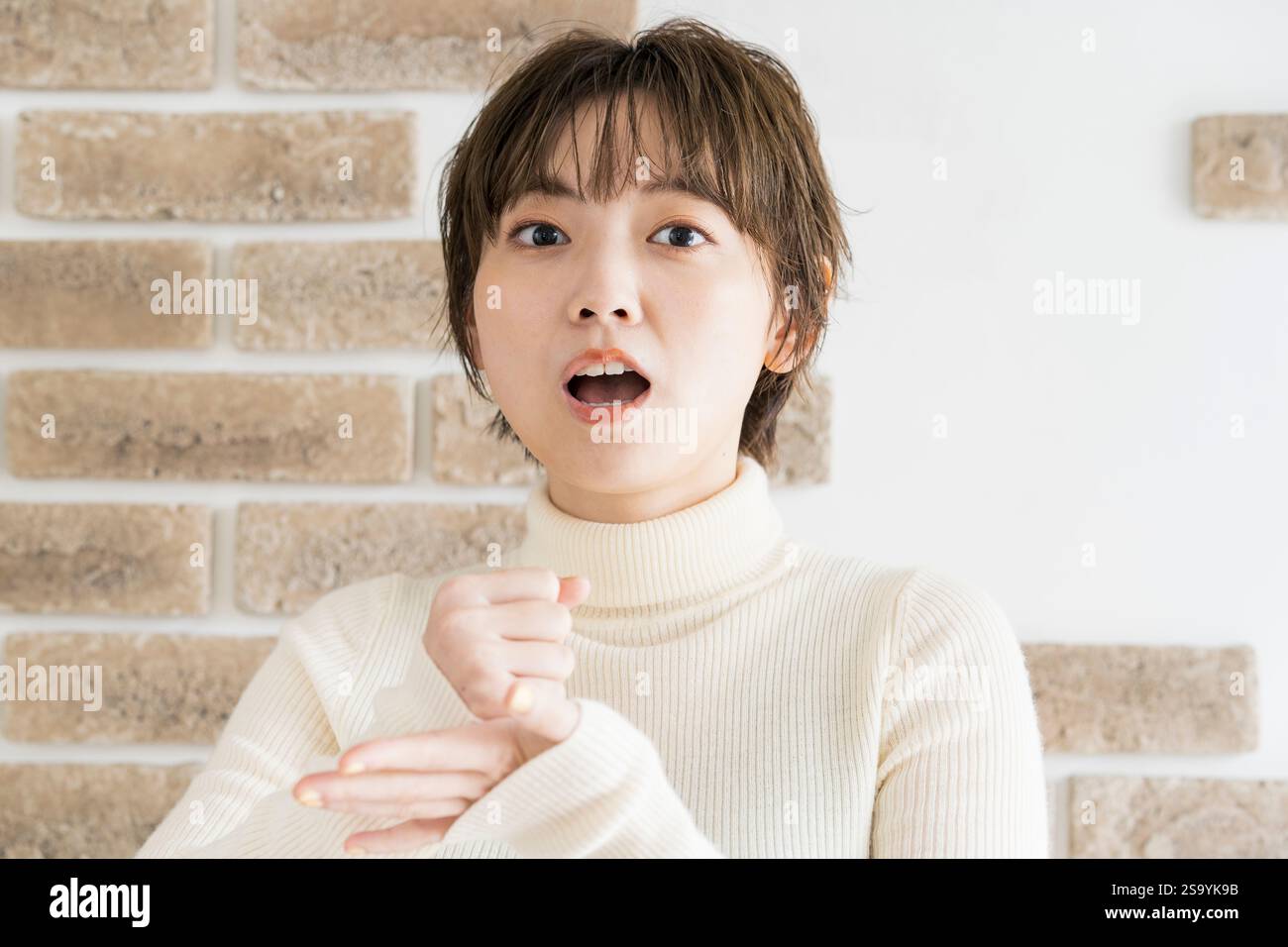 Young woman making an inspirational pose with both hands Stock Photo ...
