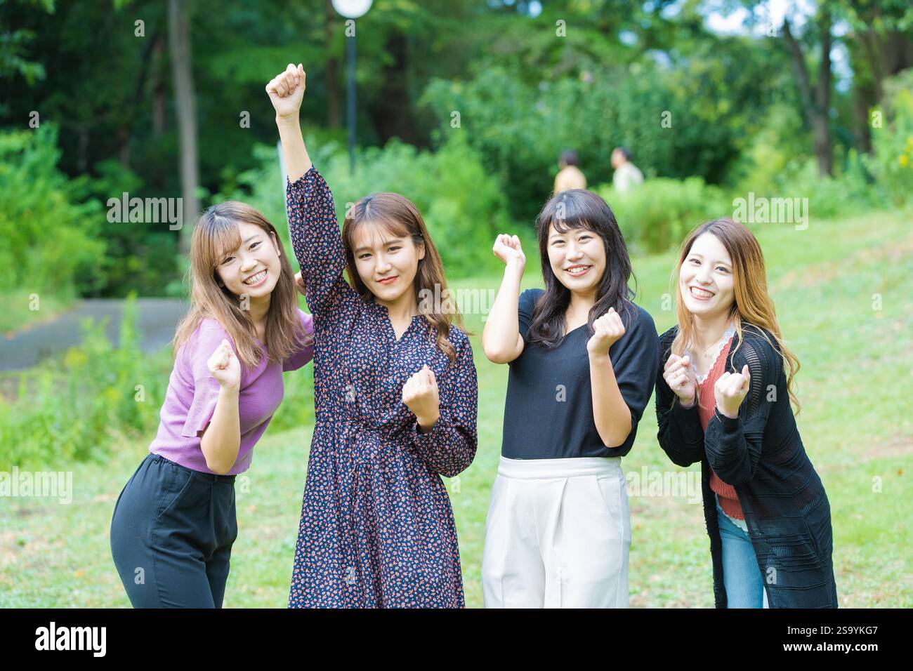 Four women cheering Stock Photo - Alamy