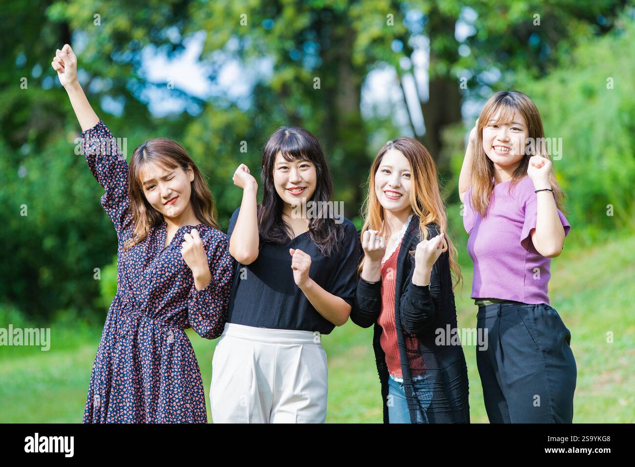 Four women cheering Stock Photo - Alamy