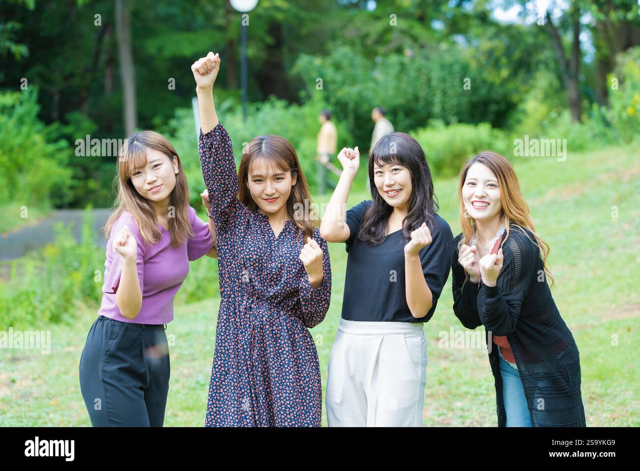 Four women cheering Stock Photo - Alamy