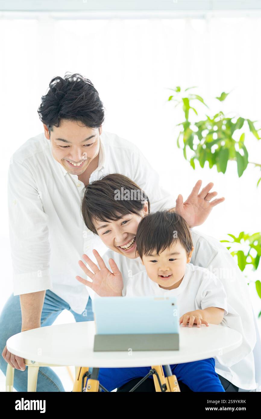 Parents and children communicating online using a tablet PC Stock Photo ...