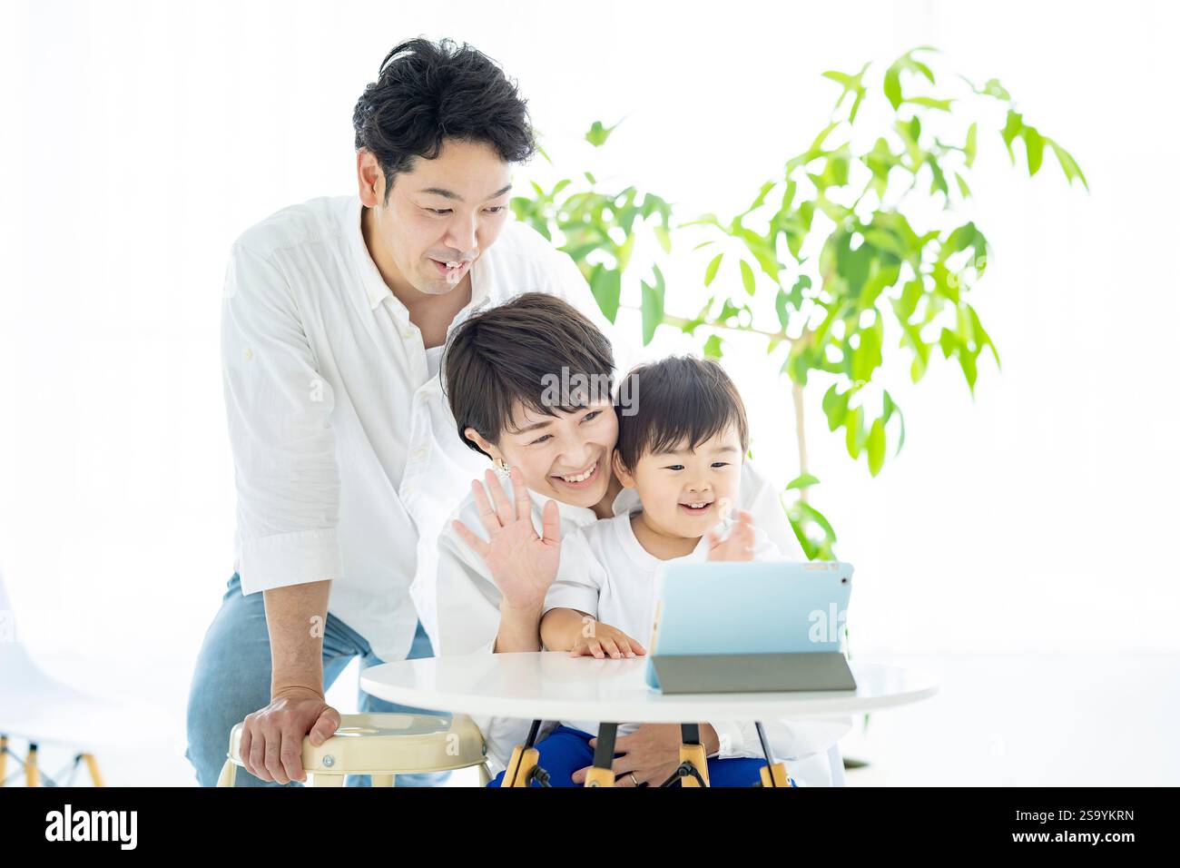 Parents and children communicating online using a tablet PC Stock Photo ...