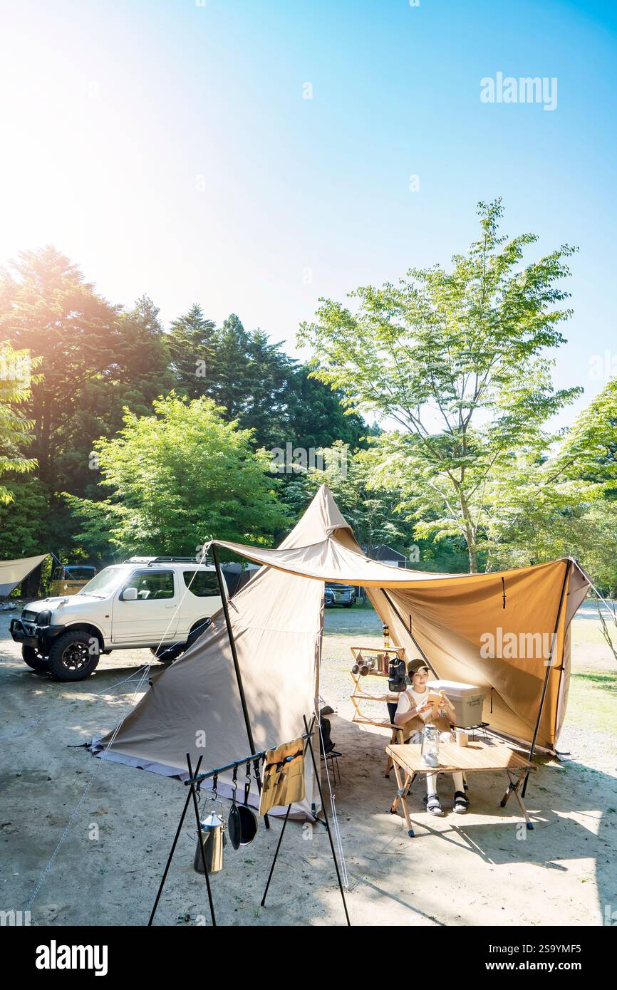 Solo camping image - young woman reading a book Stock Photo - Alamy