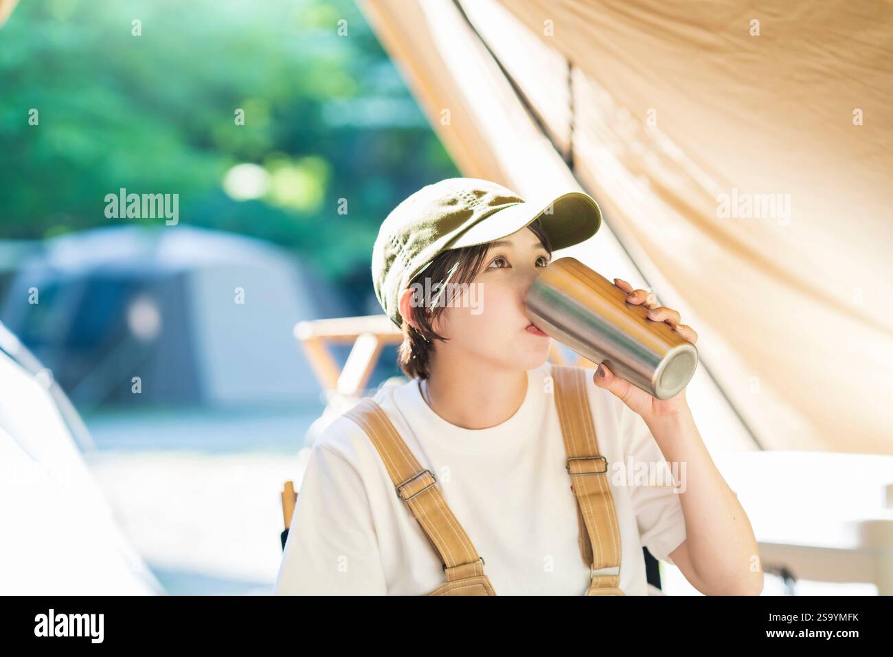 Solo camping image - young woman drinking alcohol Stock Photo - Alamy