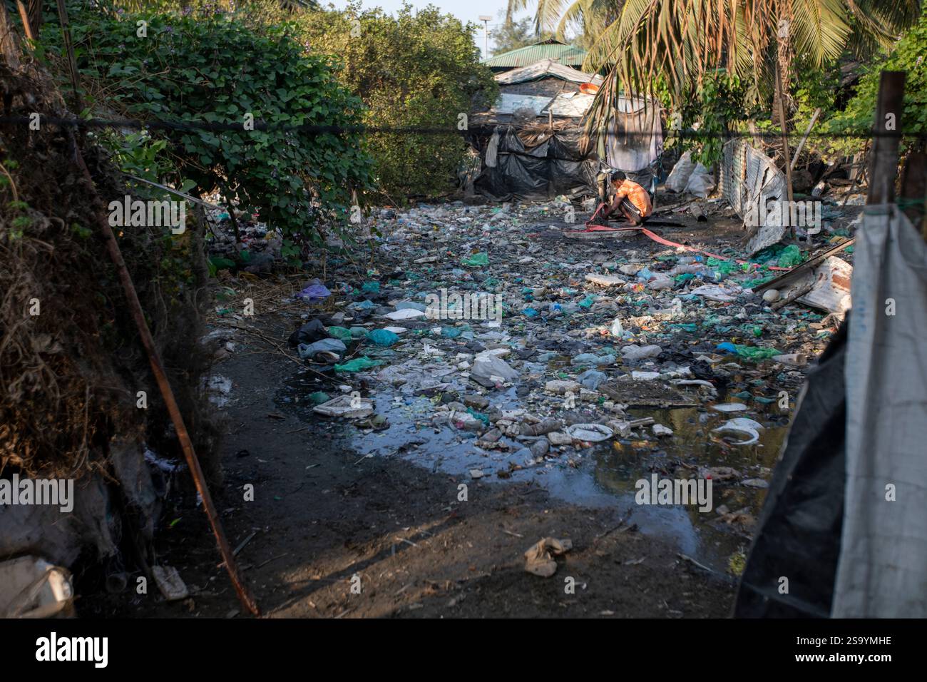 Plastic waste from hotels and resorts dumped in a pond at Saint Martin ...