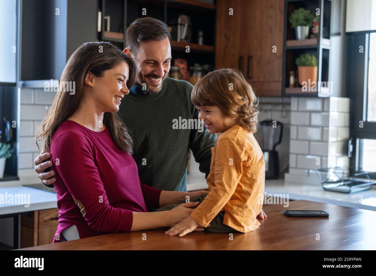 Happy family having fun in the kitchen, spending quality time together ...
