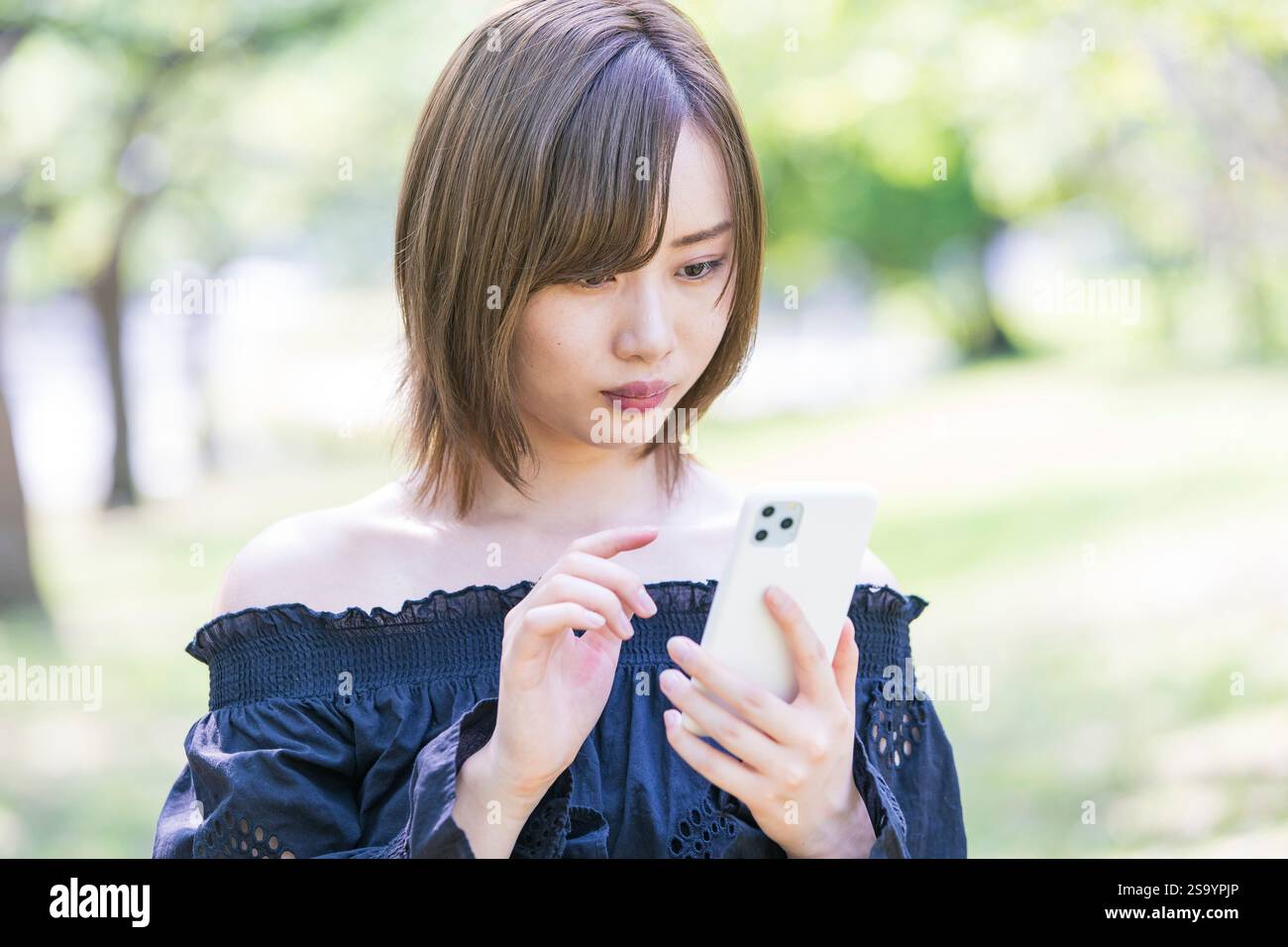 Woman operating a smartphone Stock Photo - Alamy